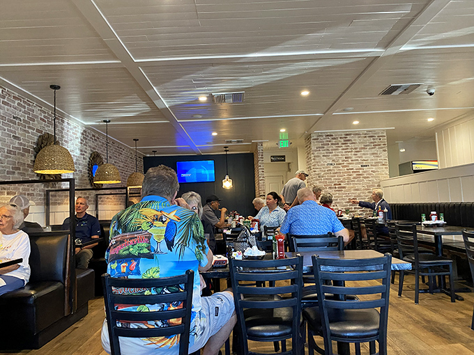 The dining room hums with the satisfied murmurs of locals and tourists alike. That shirt says it all &ndash; Florida living at its finest.