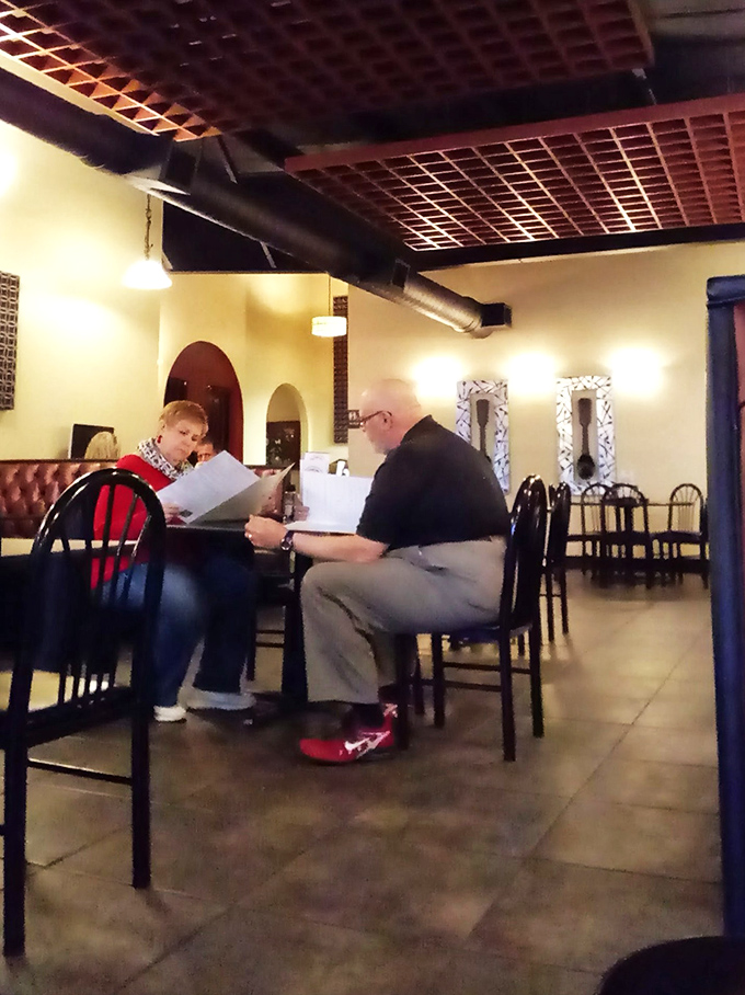 The quiet intensity of menu contemplation&mdash;a sacred moment when diners silently debate between the tried-and-true favorite or the tempting daily special.