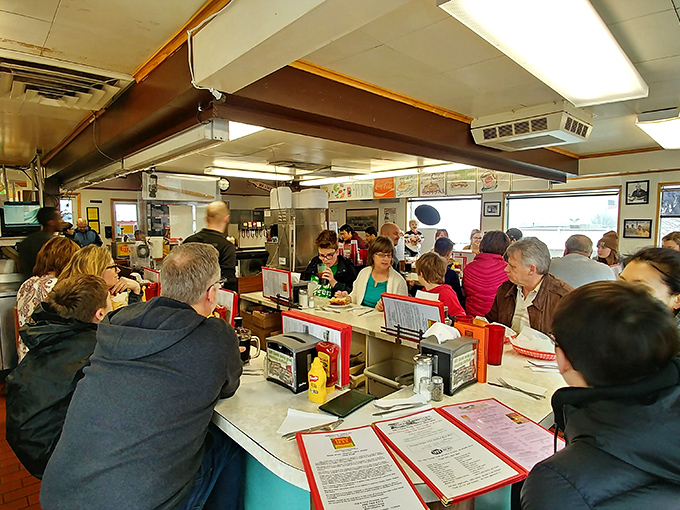 The best kind of social network! Hungry patrons huddle around the counter, united by the universal language of good food and the anticipation of those first delicious bites.