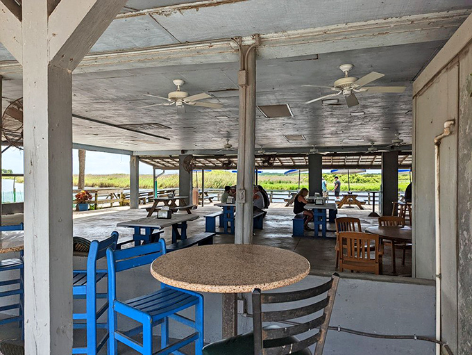 The covered dining area offers respite from Florida's relentless sun while ceiling fans create the illusion that calories don't count here.