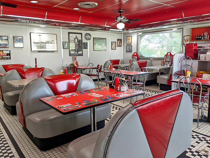 The dining area's red and chrome symphony creates the perfect stage for the comfort food drama about to unfold on your plate.