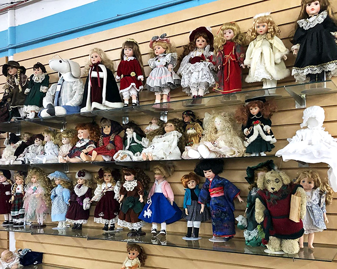 Porcelain dolls gaze down like dignified witnesses to childhood memories, awaiting new families to cherish them.