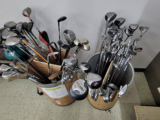Golf clubs gathered like old friends at a reunion. "Remember that time you helped sink a birdie? No? Well, there's always the next owner."