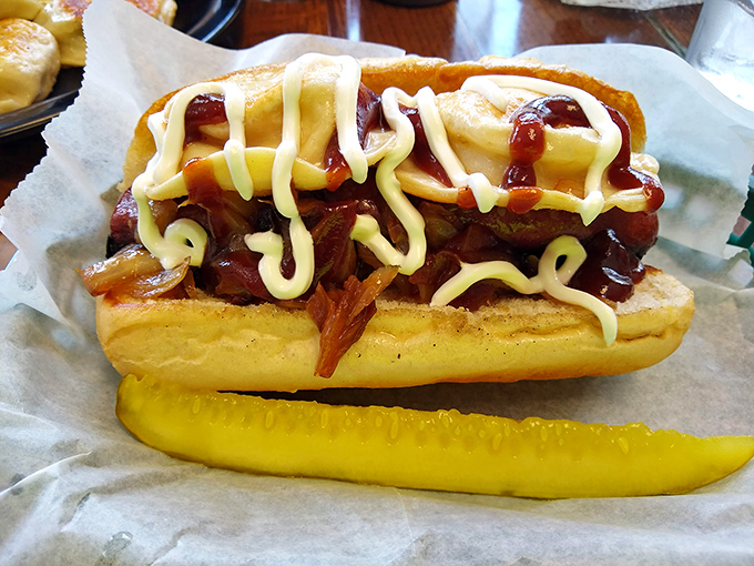 Even the humble hot dog gets the Eastern European treatment here, nestled in a soft bun and topped with what appears to be a symphony of savory additions.