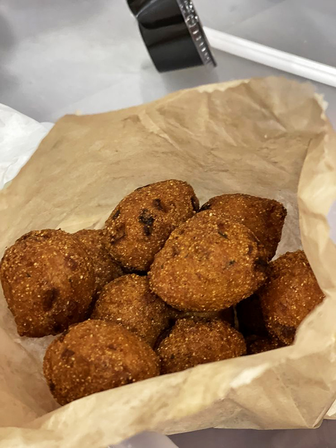 Hush puppies huddled together like little fried conspirators plotting to steal the spotlight from the chicken. Good luck with that!