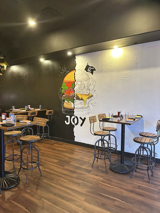 The artistic burger mural serves as both decoration and mission statement: at Joy Burgers, burgers aren't just food&mdash;they're a lifestyle.