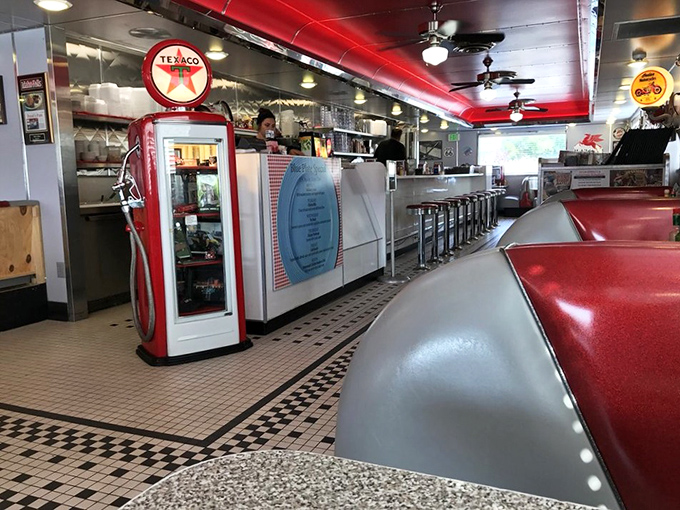The counter view reveals the diner's heart&mdash;a vintage gas pump display, chrome finishes, and the promise of meals made with equal parts nostalgia and care. 