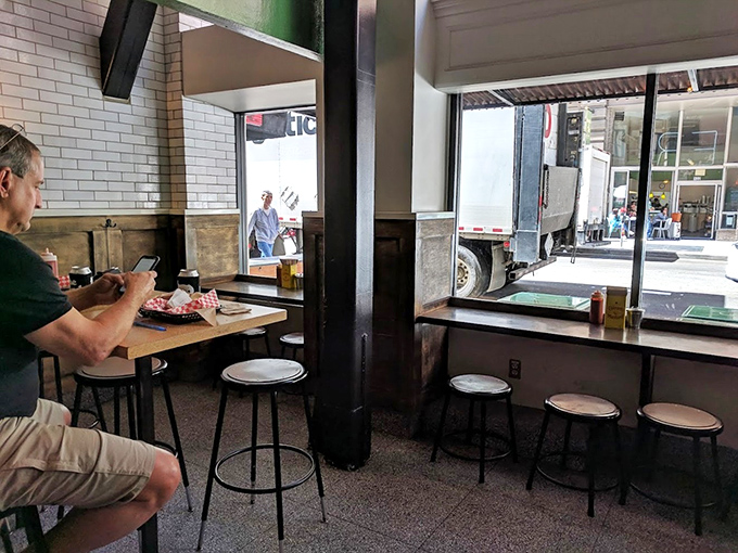 Simple pleasures: wooden tables, industrial pipes, and a window seat where you can contemplate life while contemplating your next bite.