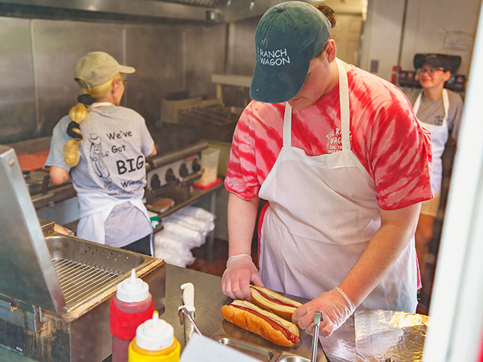 Behind every great hot dog is a dedicated team with mustard and ketchup at the ready. Culinary choreography at its finest.