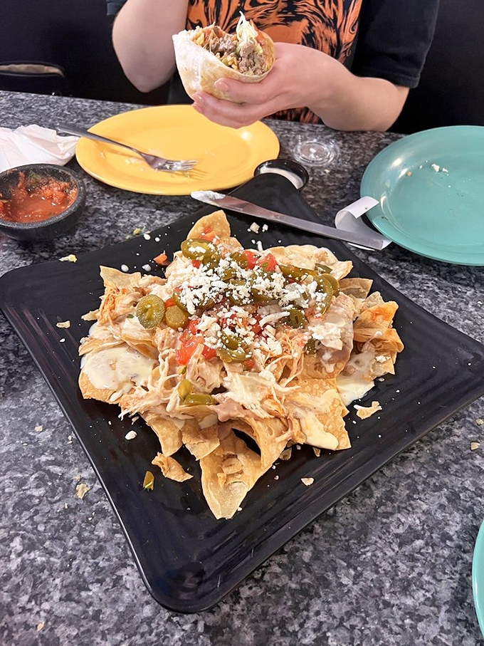 These aren't your average ballpark nachos. This mountain of chips, cheese, and toppings requires strategy, stamina, and possibly a support group.