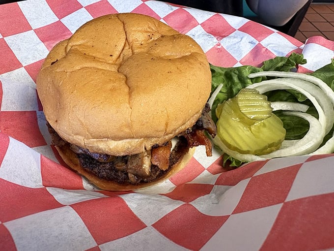 This isn't just a burger &ndash; it's a testament to diner perfection, complete with the holy trinity of pickle, onion, and fresh greens.