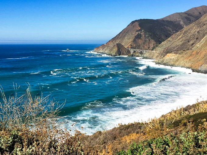 The dance between turquoise waters and rugged cliffs creates a hypnotic visual symphony. This view alone is worth the white-knuckle drive.