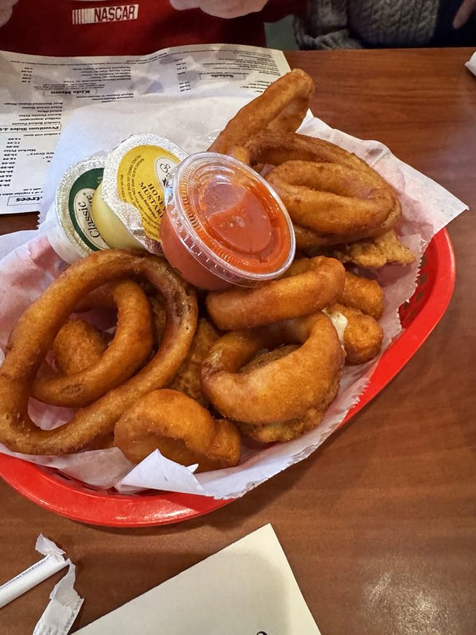 Onion rings stacked like golden halos, proving that sometimes the simplest pleasures are worth every single calorie.