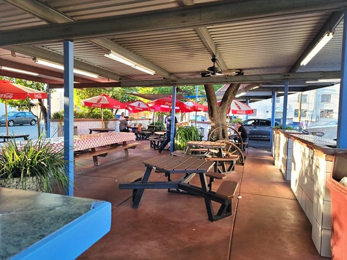 Red umbrellas provide shade while you contemplate life's important questions, like "Should I order another root beer float?"