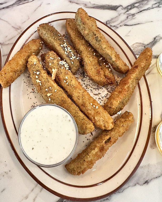 Pickle fries &ndash; the unsung heroes of the appetizer world &ndash; crispy, tangy soldiers standing at attention beside their creamy dipping companion.