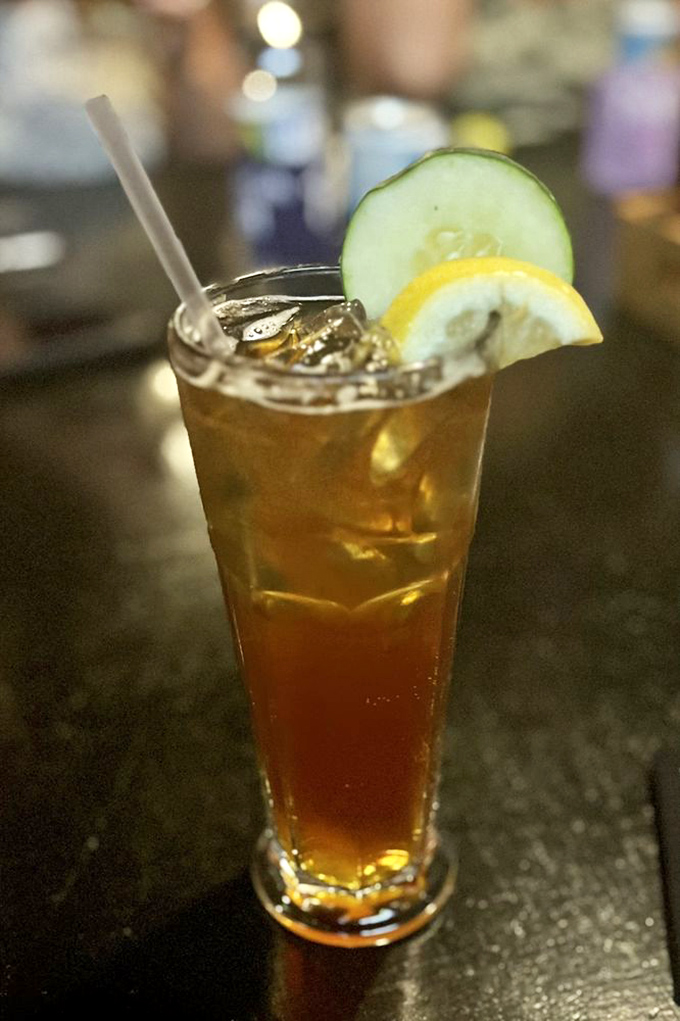 A Pimm's Cup garnished with cucumber and lemon&mdash;summer in a glass. The unofficial drink of Wimbledon finds a happy home in Nashville.