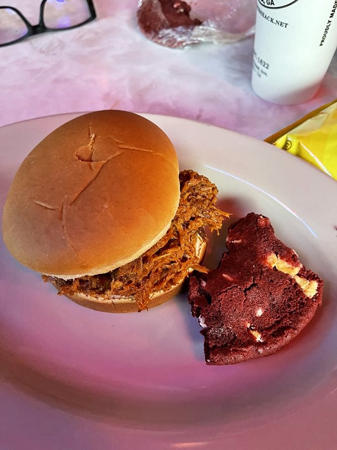 The pulled pork sandwich that's worth every napkin you'll sacrifice to the barbecue gods, with a slice of red velvet cake standing by.