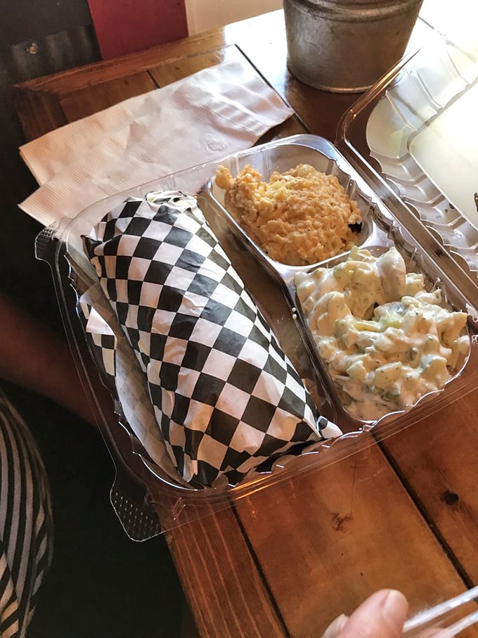 The humble wrap, elevated to art form with a checkered paper tuxedo and sides that refuse to be upstaged by the main attraction.