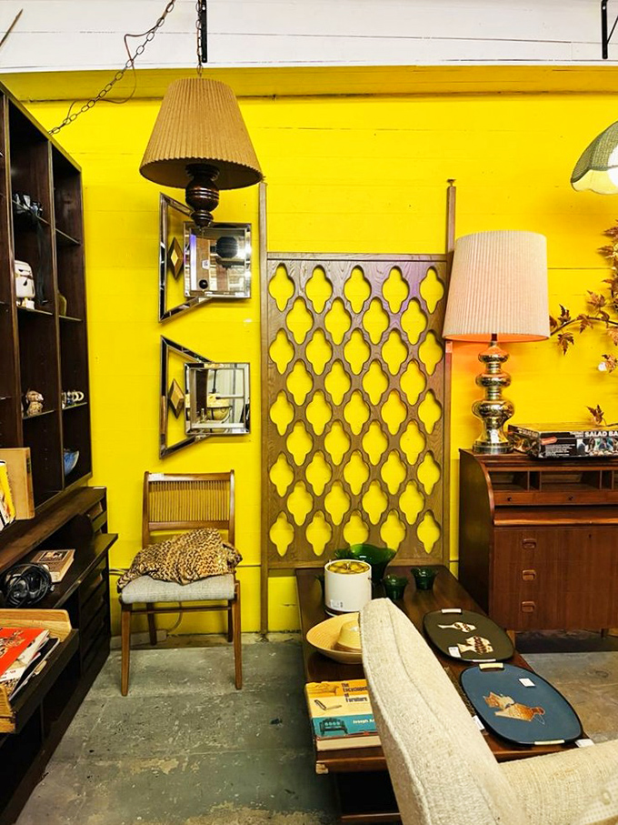 That vibrant yellow wall isn't just a backdrop; it's a mid-century mood board waiting to transform your living room.