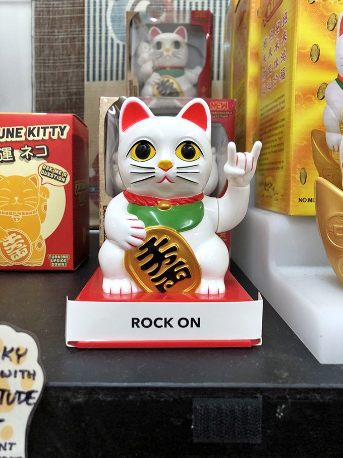 "Rock on" indeed! This rebellious little feline throws the universal sign of rock while still maintaining its day job of attracting good fortune.