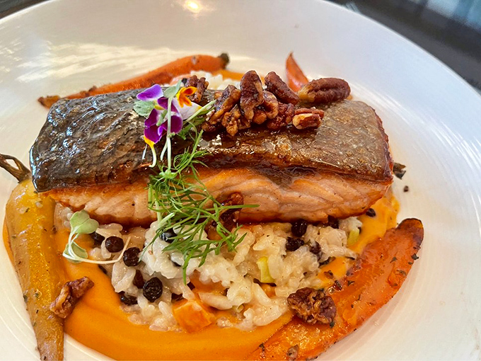 Salmon that's dressed better than most people at dinner, perched atop a colorful medley that's both frame and flavor enhancer.