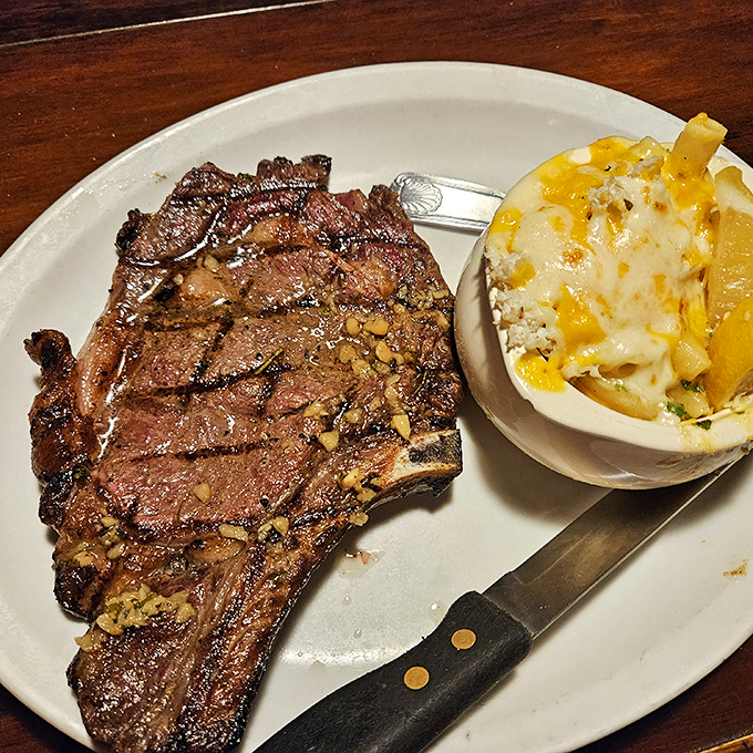 A steak with grill marks so perfect they could be framed, paired with a loaded potato that's dressed for its own special occasion.