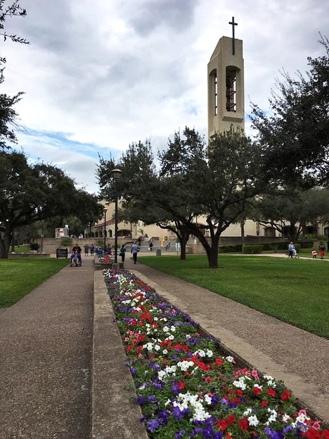 The church tower in San Juan reaches skyward, surrounded by greenery that softens the edges of urban life in this coastal community.