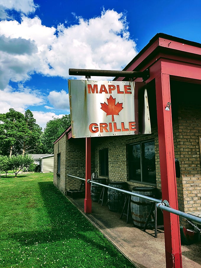 The Maple Grille's humble sign swinging in the breeze promises wood-fired delights in rural Hemlock.