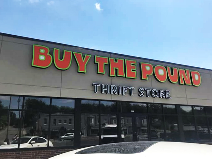 The bold green and red signage pops against the building's neutral tones. "Now Open" flags flutter with promises of discoveries.