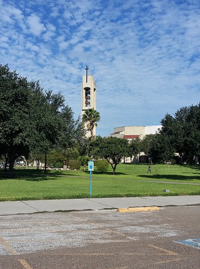 San Juan's church stands as a spiritual landmark, where the path lined with colorful flowers invites both contemplation and community gathering.