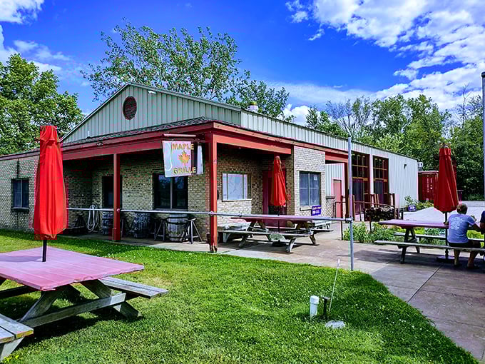 Picnic tables and red umbrellas create a casual vibe where the steaks are serious but pretension is banned.