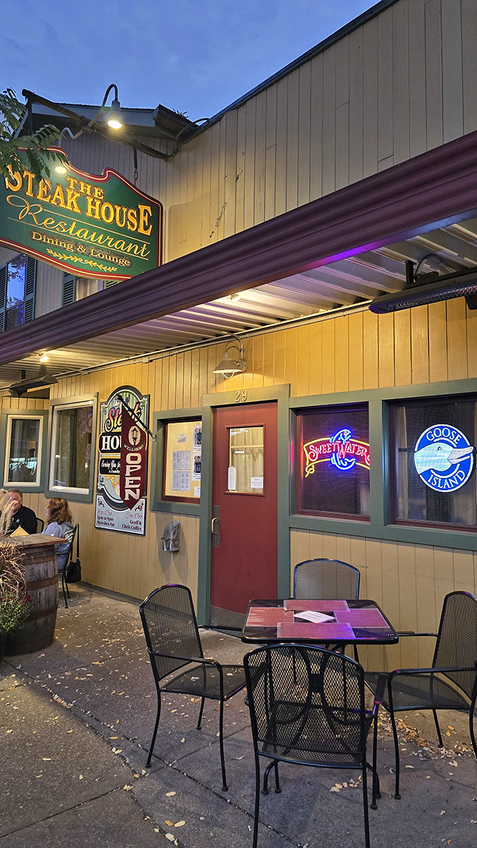 Neon signs glow in the windows as evening falls on The Steak House. Inside, generations of steak expertise await hungry visitors.