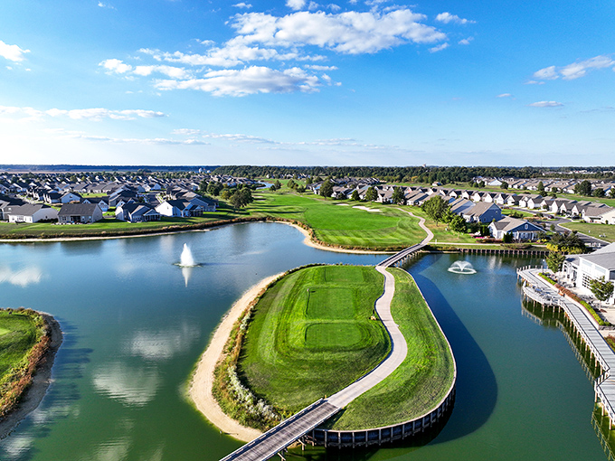 An aerial view reveals Heritage Shores' masterful integration of water features, green fairways, and community living in perfect harmony.