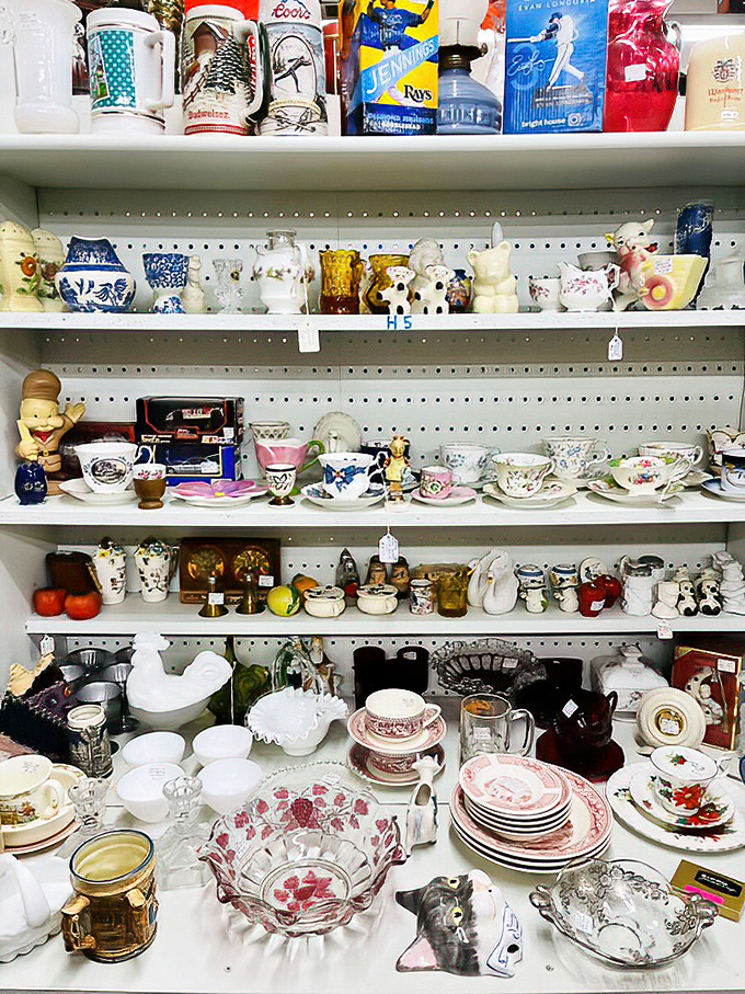Teacups and collectibles from grandma's era line these shelves, each piece whispering stories of Sunday dinners and special occasions.