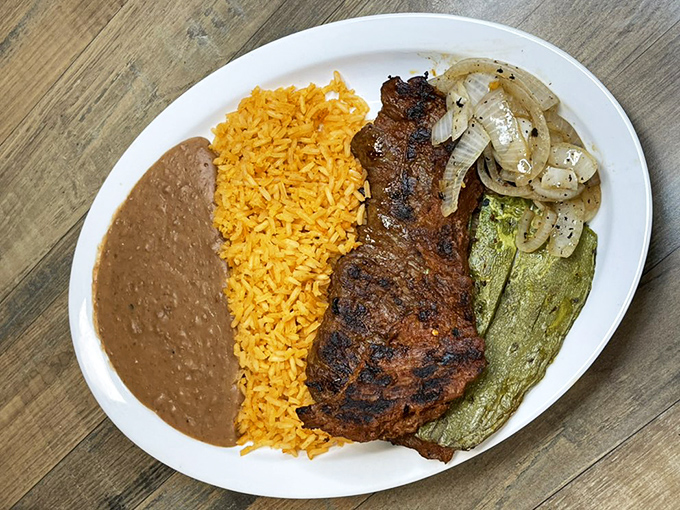 The arrachera plate: where perfectly grilled steak meets colorful sides. This isn't just dinner&mdash;it's a vacation for your taste buds without leaving Iowa.