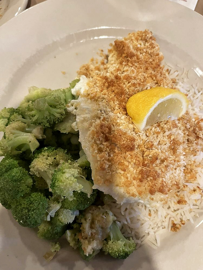The crumb-topped haddock that launched a thousand return visits. Paired with bright broccoli, it's the seafood dish that even seafood skeptics order repeatedly.