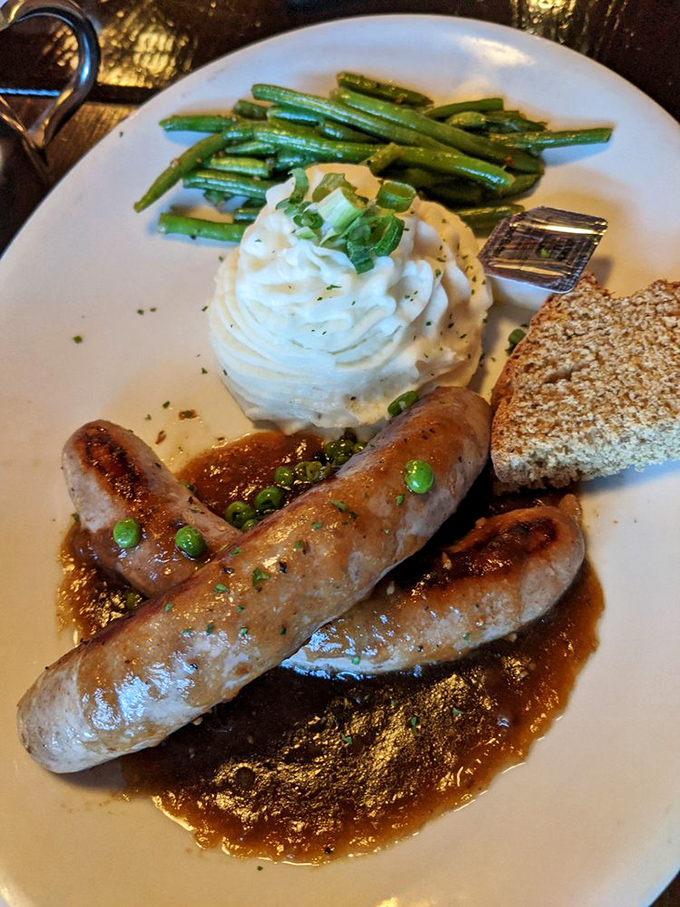 Bangers & Mash: where sausages with personality meet potatoes whipped to cloud-like perfection, all swimming in gravy that demands to be sopped up.