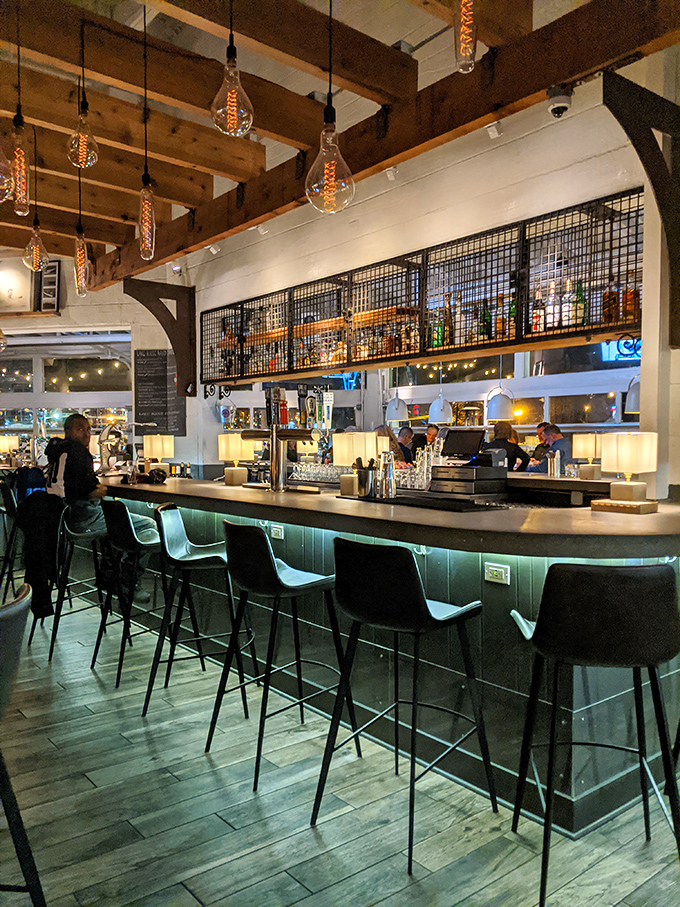 Edison bulbs cast a warm glow over a bar that invites lingering conversations and "just one more" of whatever you're having.