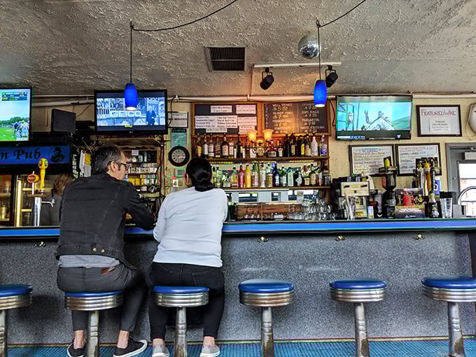 A bar that prioritizes function over flash. No mixology theatrics here&mdash;just solid pours and a front-row seat to the kitchen action.