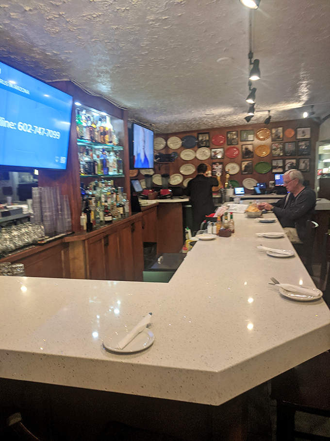 The bar isn't just serving drinks&mdash;it's showcasing art. Those colorful plates lining the wall have witnessed countless celebrations and consolations.