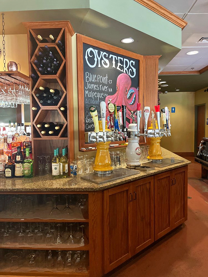 The bar area showcases an impressive selection of spirits alongside a chalkboard listing the day's oyster varieties. That octopus artwork seems to approve of your drink choice.