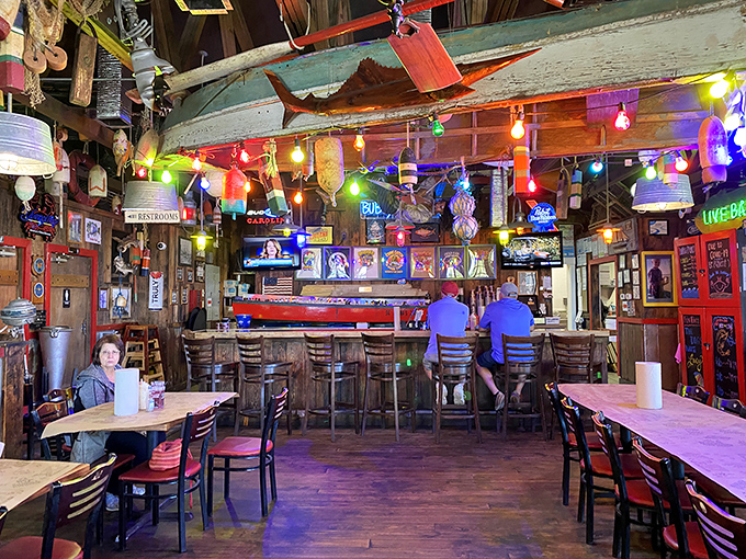 The bar area could be a museum of coastal memorabilia, where cold drinks flow and fishing tales grow taller with each round.