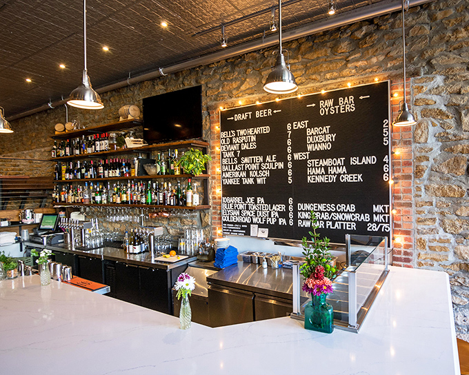 A chalkboard menu of oceanic treasures that changes with the tides. Behind it, enough spirits to make any sailor feel at home.