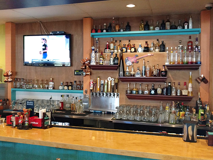 A tequila library that would make Ernest Hemingway switch from mojitos. The turquoise shelving adds that perfect pop of color.