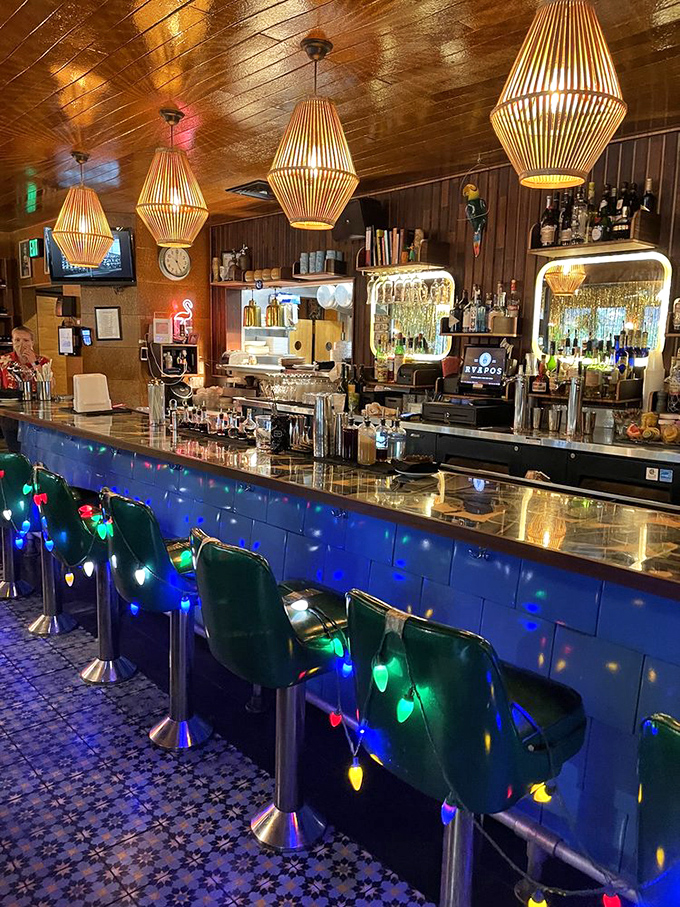 Bar stools wrapped in Christmas lights under bamboo pendant lamps? This bar doesn't just serve drinks&mdash;it serves experiences.