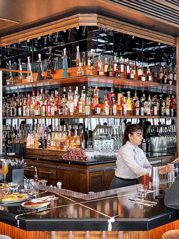 A bartender crafts drinks beneath what might be the most impressive spirits collection ever to grace a diner&mdash;this ain't your grandpa's coffee counter.