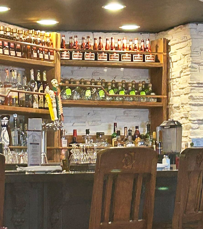 A bar stocked with enough tequila varieties to make you reconsider your "I'll just have one" policy. The bottles stand at attention like soldiers of celebration.