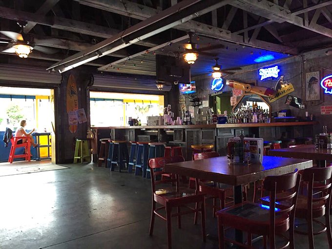 The bar area glows with neon signs and cold beer promises &ndash; a perfect refuge when your skin says "enough sun for today."