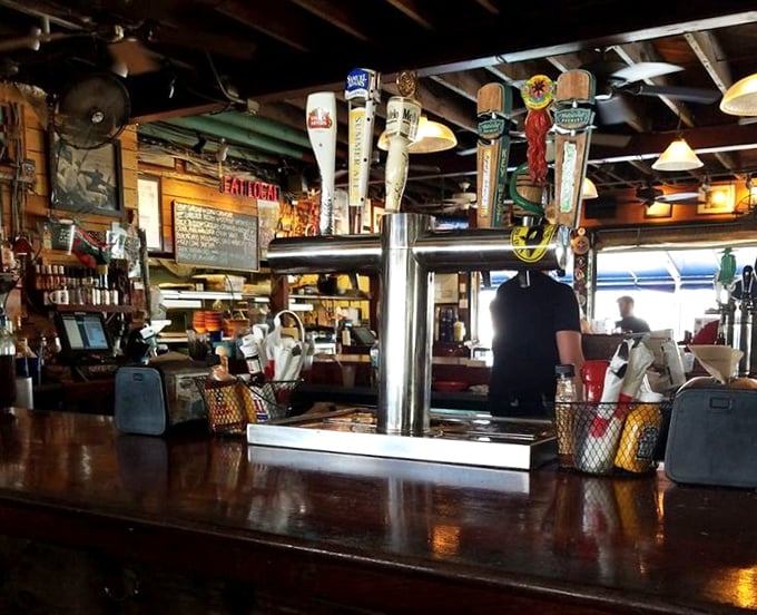 At this bar, the beer taps tell stories of thirsty fishermen and conversations that stretch into evening as naturally as the tides.