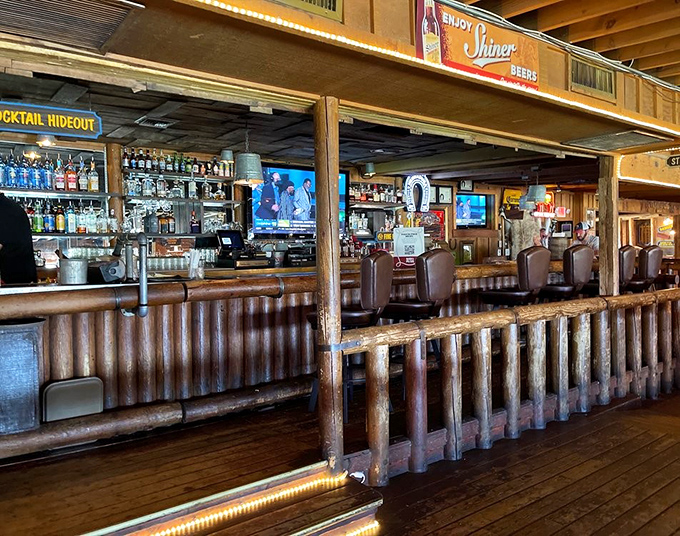 The saloon-style bar invites you to belly up and enjoy a drink while waiting for culinary magic. 